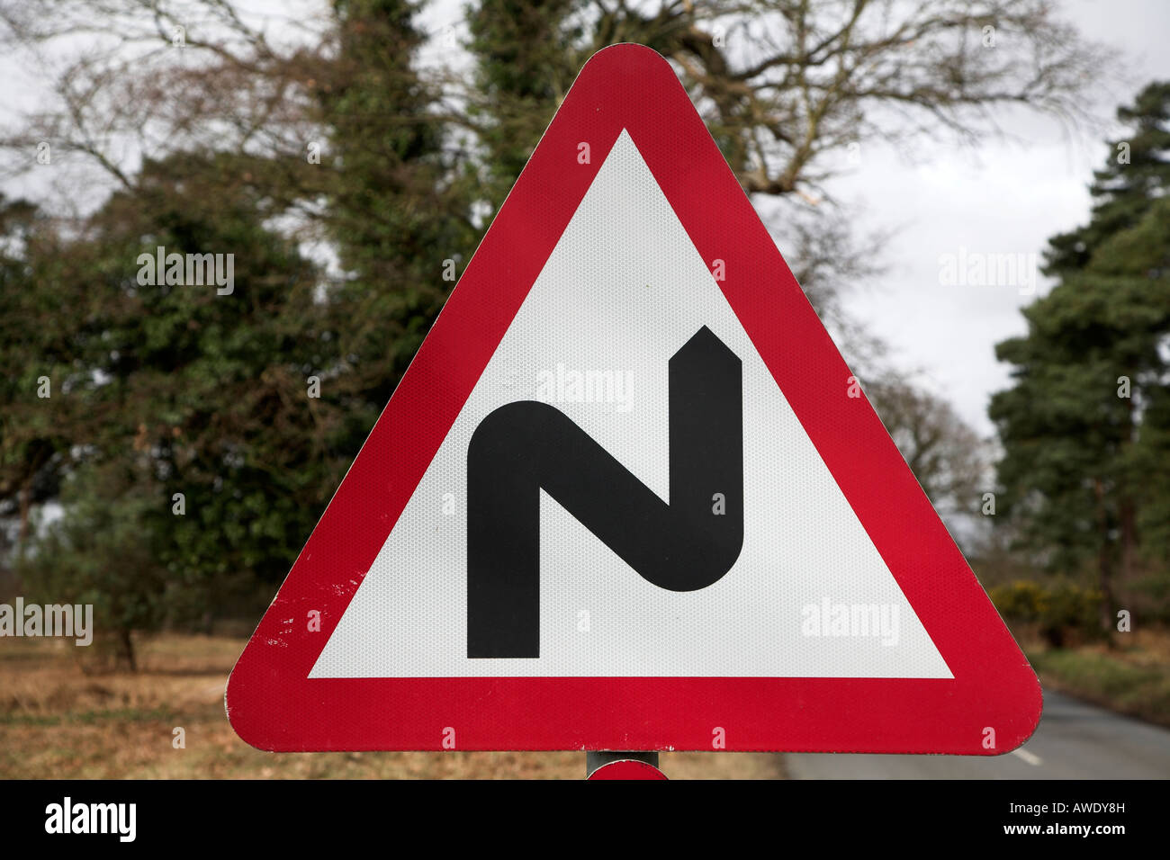 Road sign for bends ahead Stock Photo - Alamy