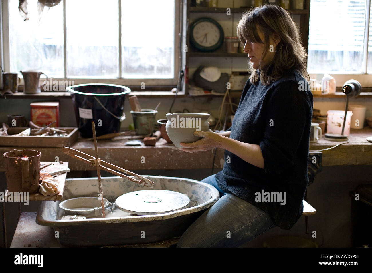 Cornish Potter Deborah Mitchell Sits at her wheel in her pottery in ...
