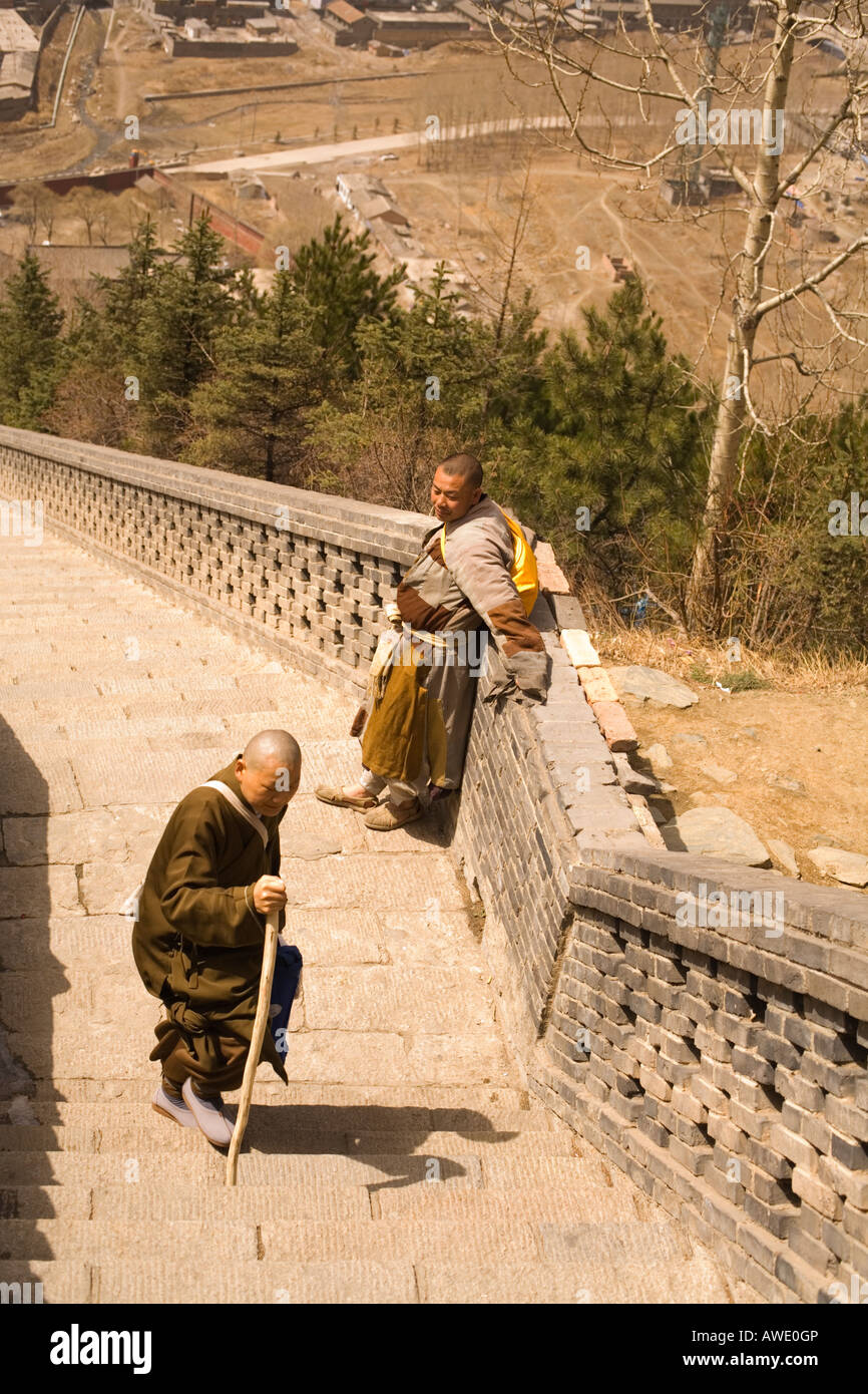 Two pilgrims climbing up the steps to a temple in Wutai Shan, People's ...