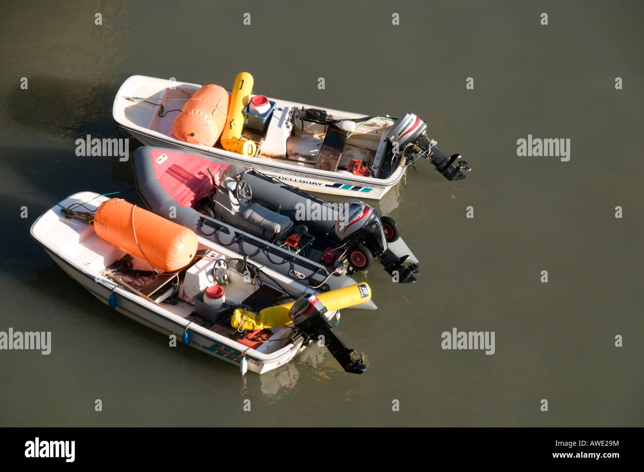 three small dinghy with outboard motors n the harbour Saundersfoot ...