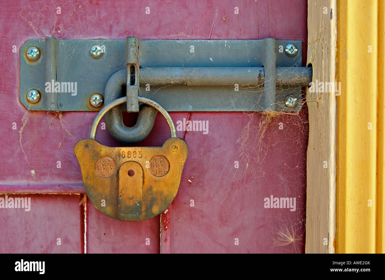 big old lock keeps this bright door shut Stock Photo - Alamy