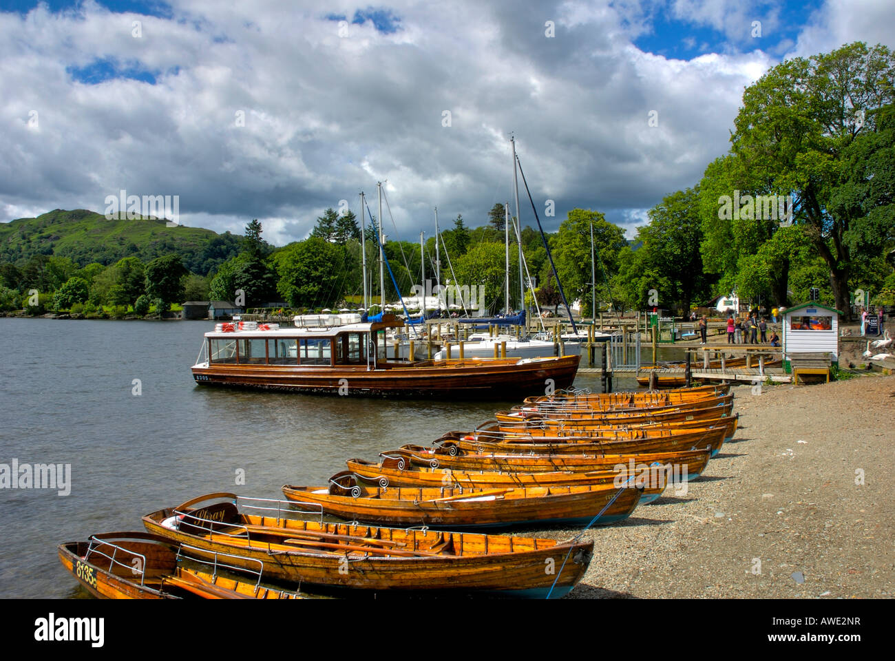 Beach and piers at Waterhead, Lake Windermere, with passenger boats and ...