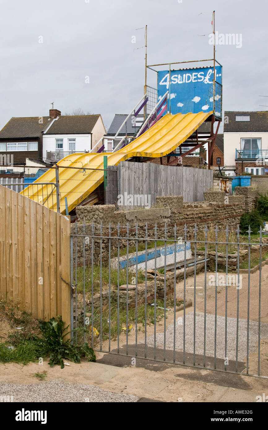 Abandoned slide ride at a seaside funfair closed for the winter Stock ...