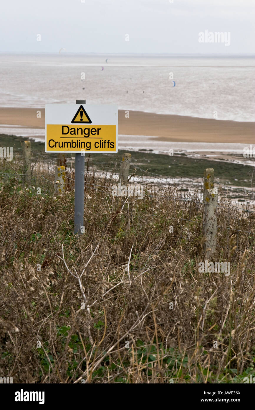 Danger Crumbling Cliffs sign on a beach cliff face Stock Photo - Alamy