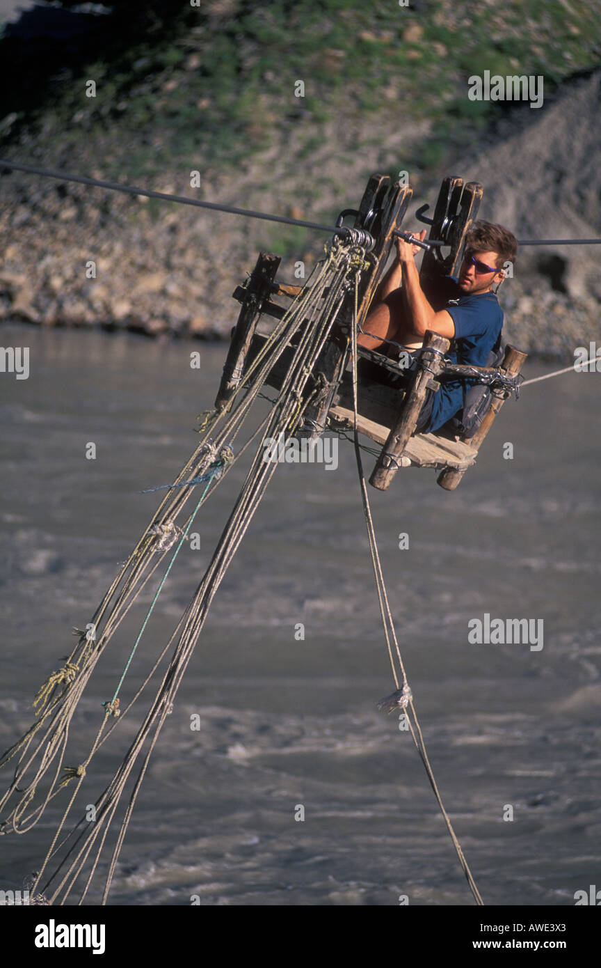 Man crossing a rope bridge, India Stock Photo - Alamy