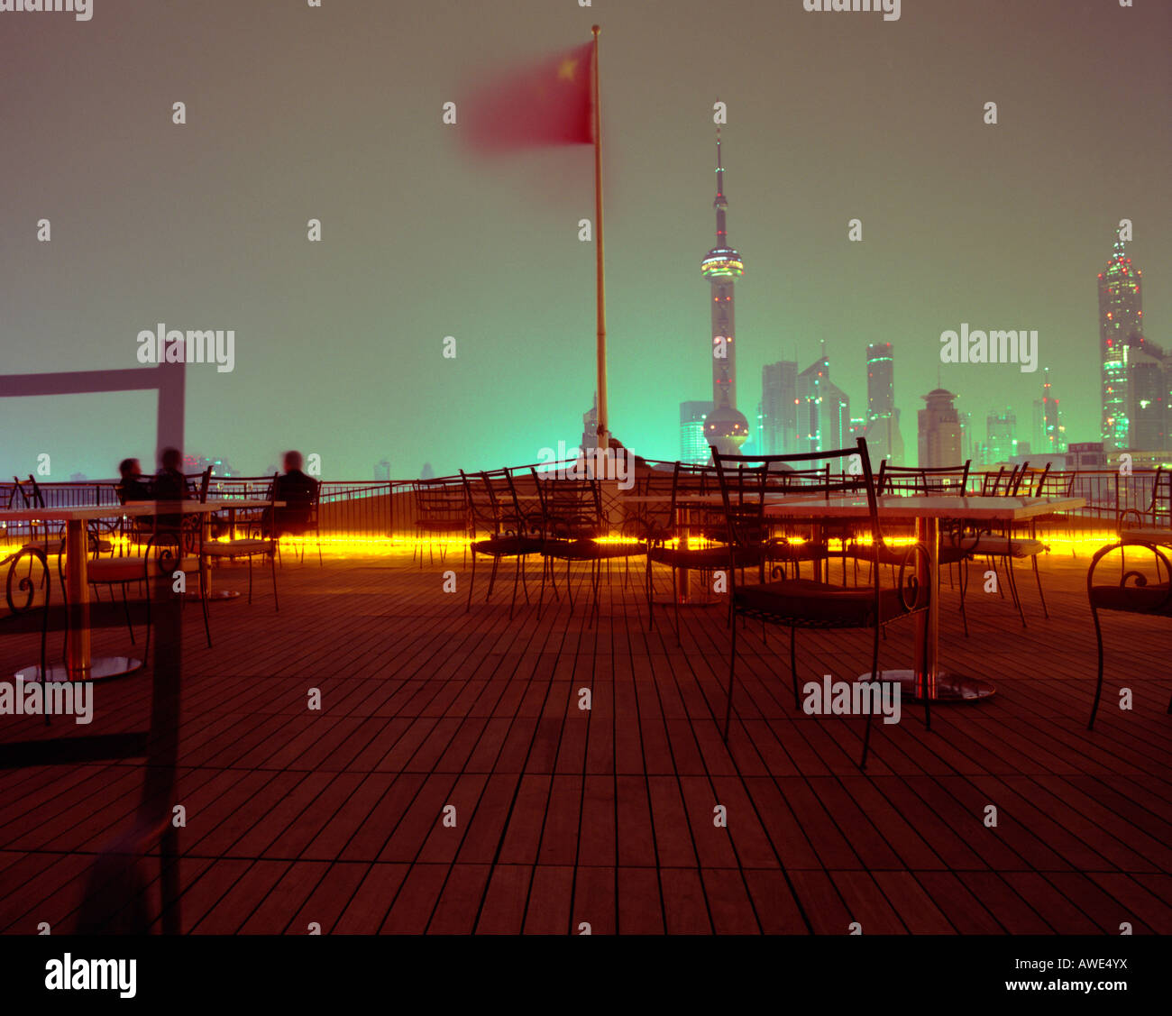 Chinese flag blows in the wind on a balcony in Shanghai, China View ...