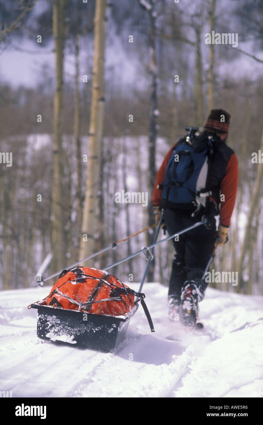Skier pulling a gear sled along a trail in the backcountry Stock Photo ...