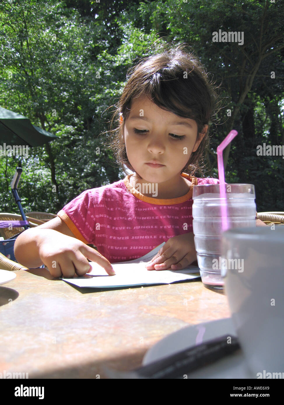 Little girl is reading a page Stock Photo - Alamy