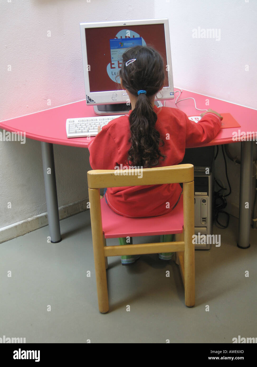 Little girl behind a computer Stock Photo - Alamy