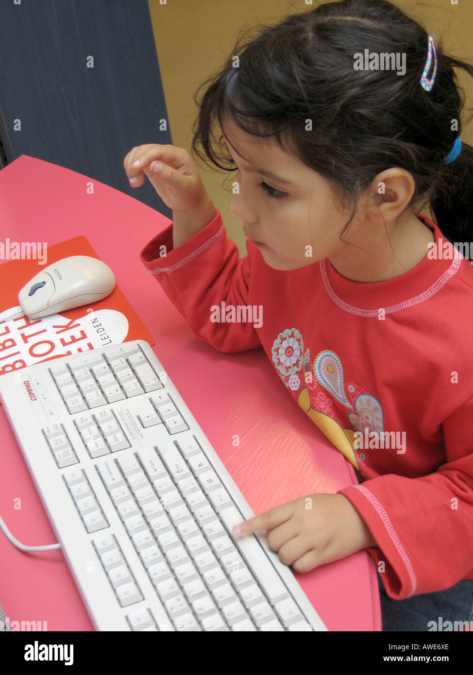 Little girl behind a computer Stock Photo - Alamy