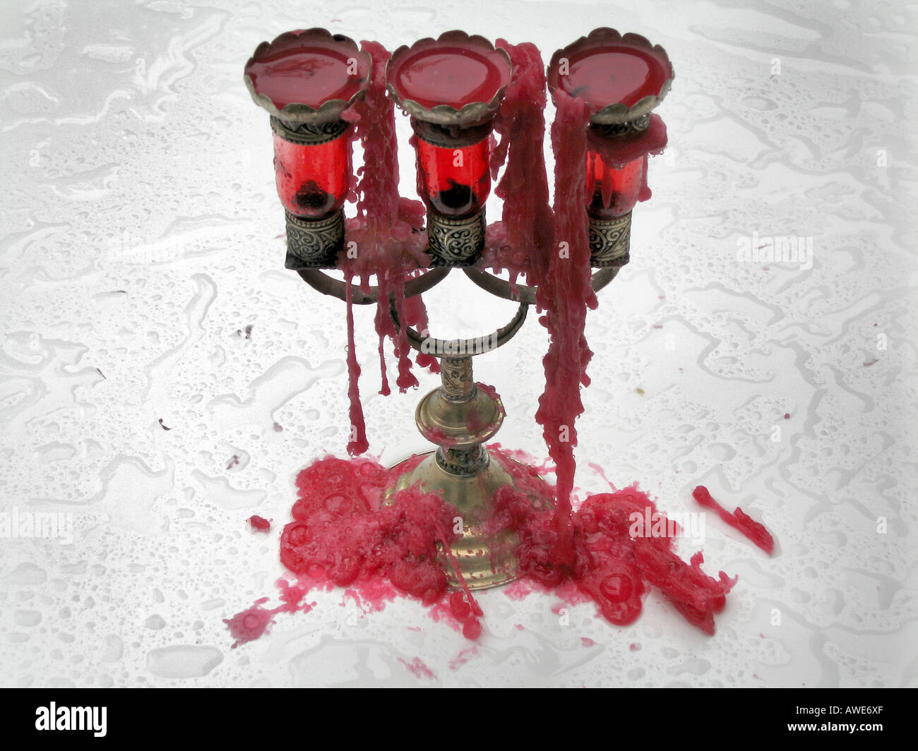A candlestick in the rain with finished candles Stock Photo - Alamy