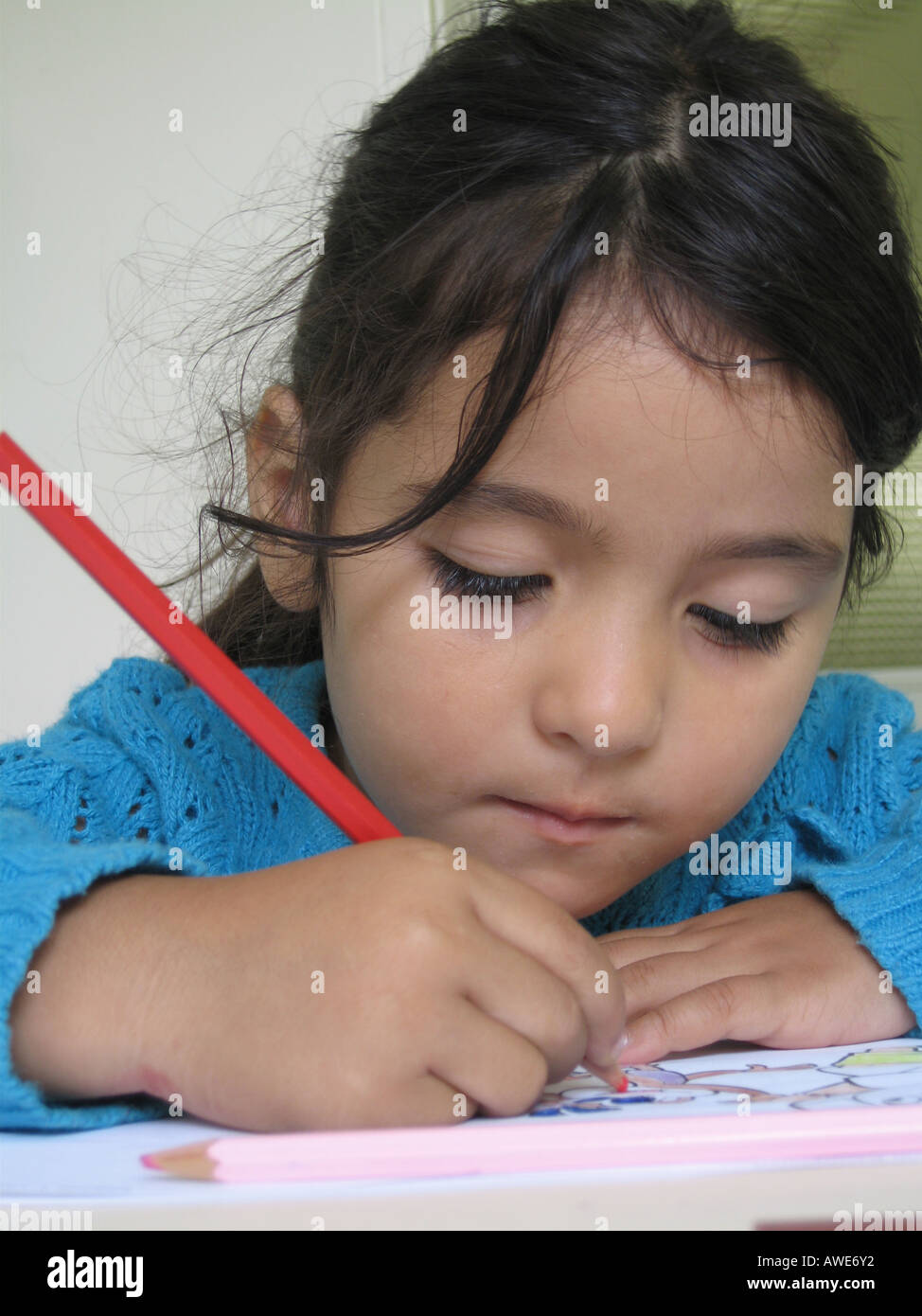 Little girl is colouring a drawing Stock Photo - Alamy