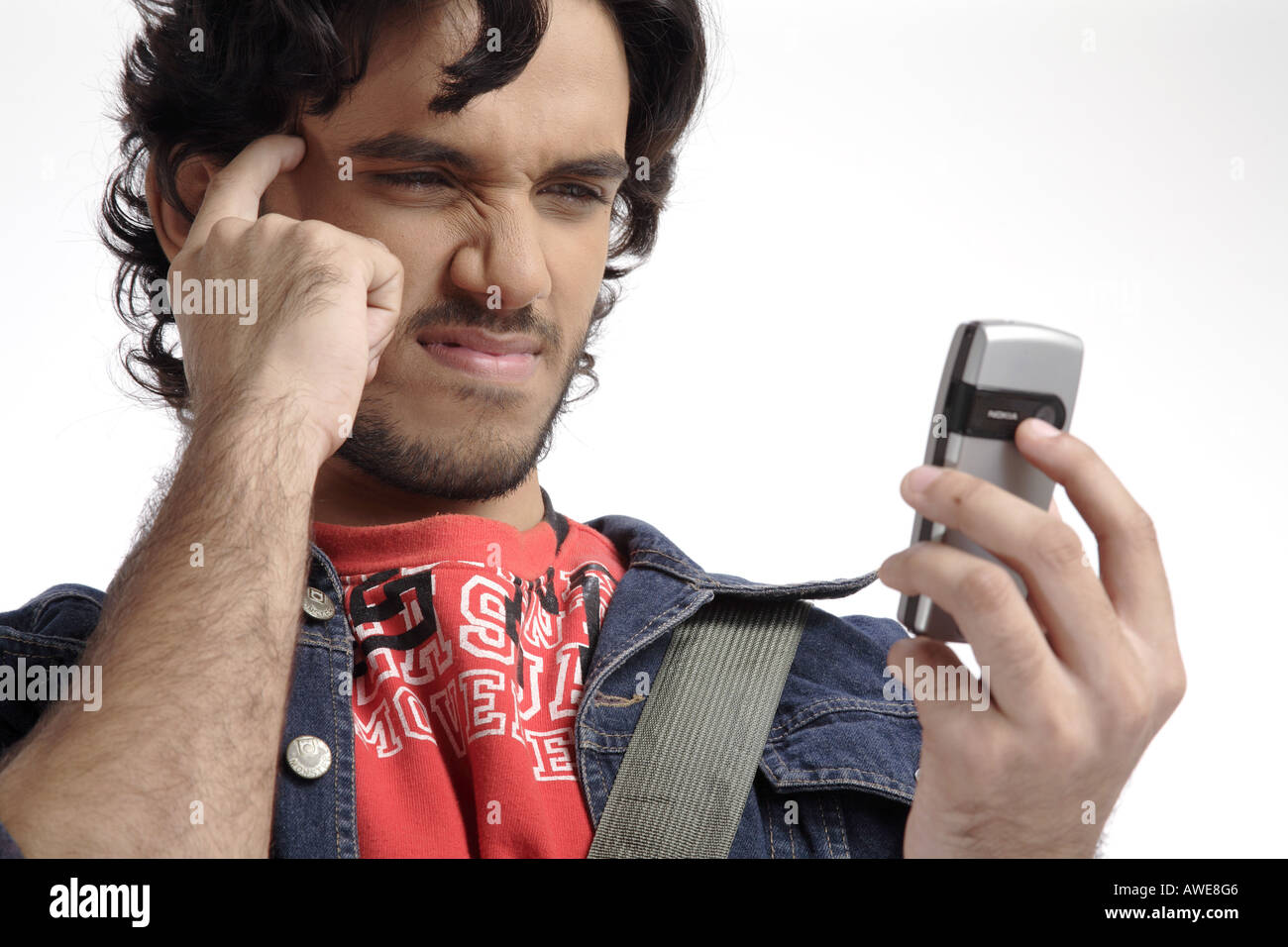 ANG200396 Teenage boy looking at sms message on cellphone Stock Photo ...