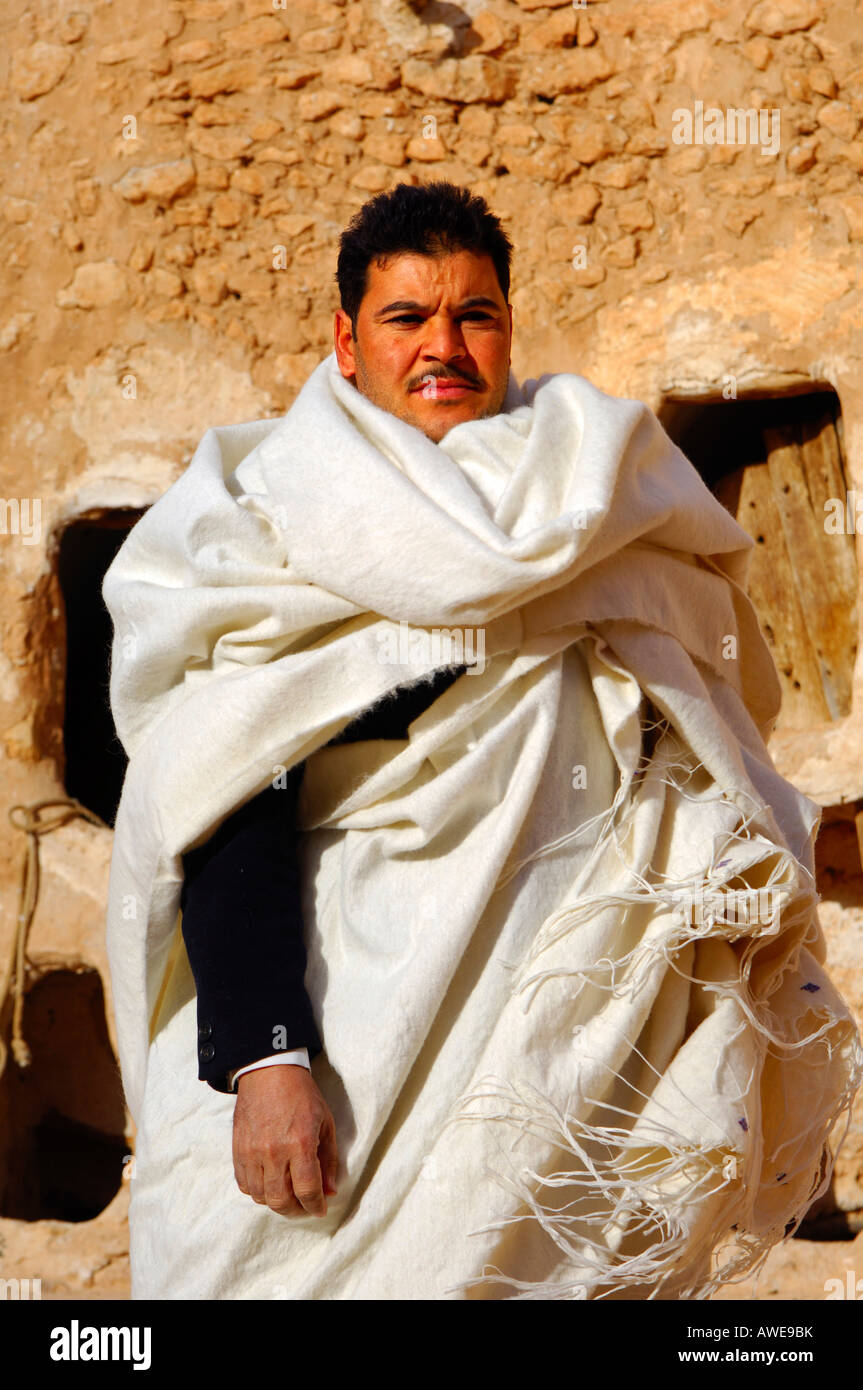 Local tourist guide in traditional Berber dress in the Berber granary ...