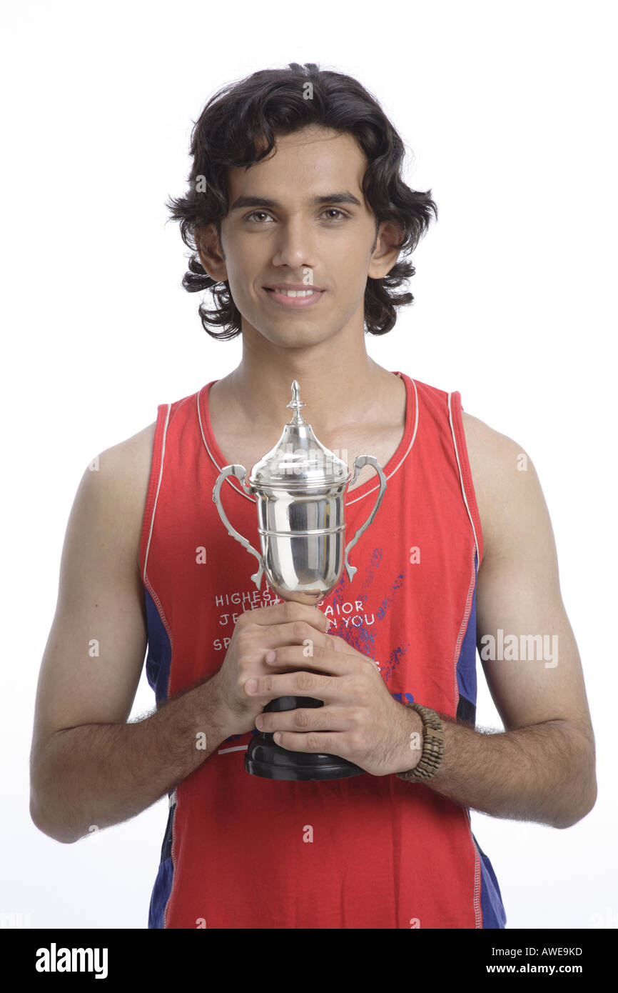 ANG200545 Teenage boy winning trophy cup holding trophy in both hands ... ANG200545 Teenage boy winning trophy cup holding trophy in both hands ...