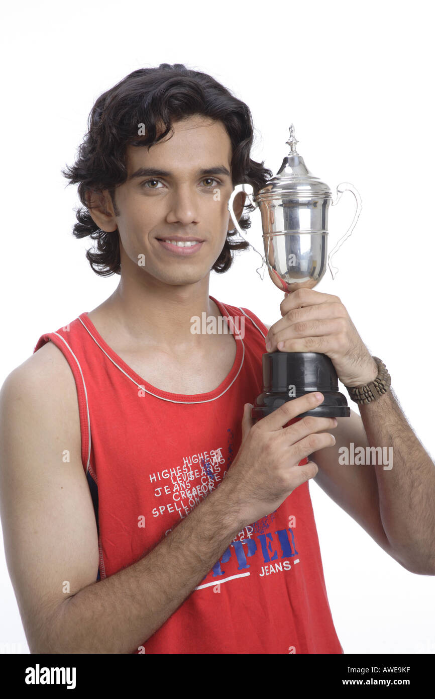 ANG200546 Teenage boy winning trophy cup raising the trophy MR 687T ...