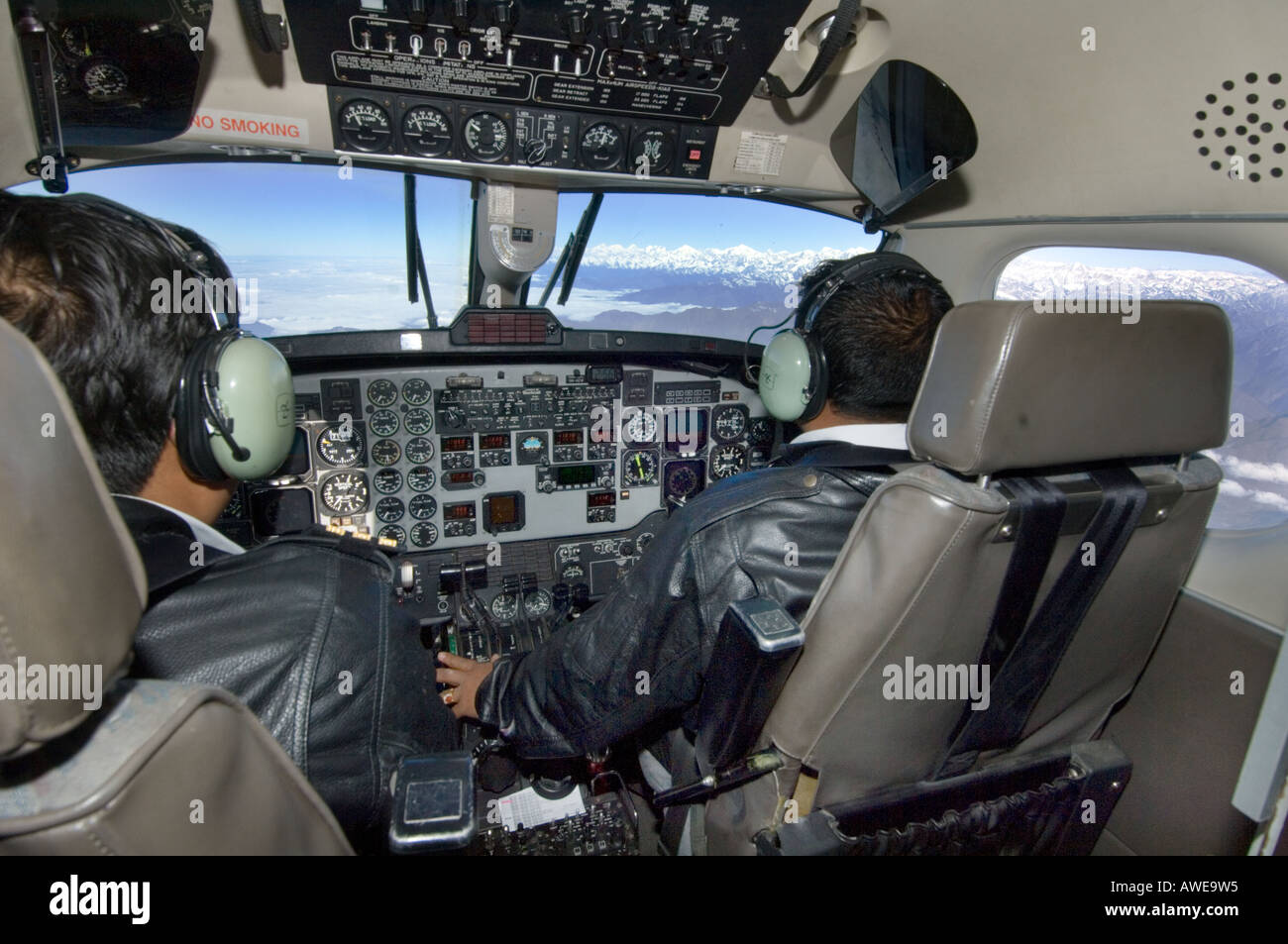 in the cockpit of an airplane plane captain and pilot flying over the ...
