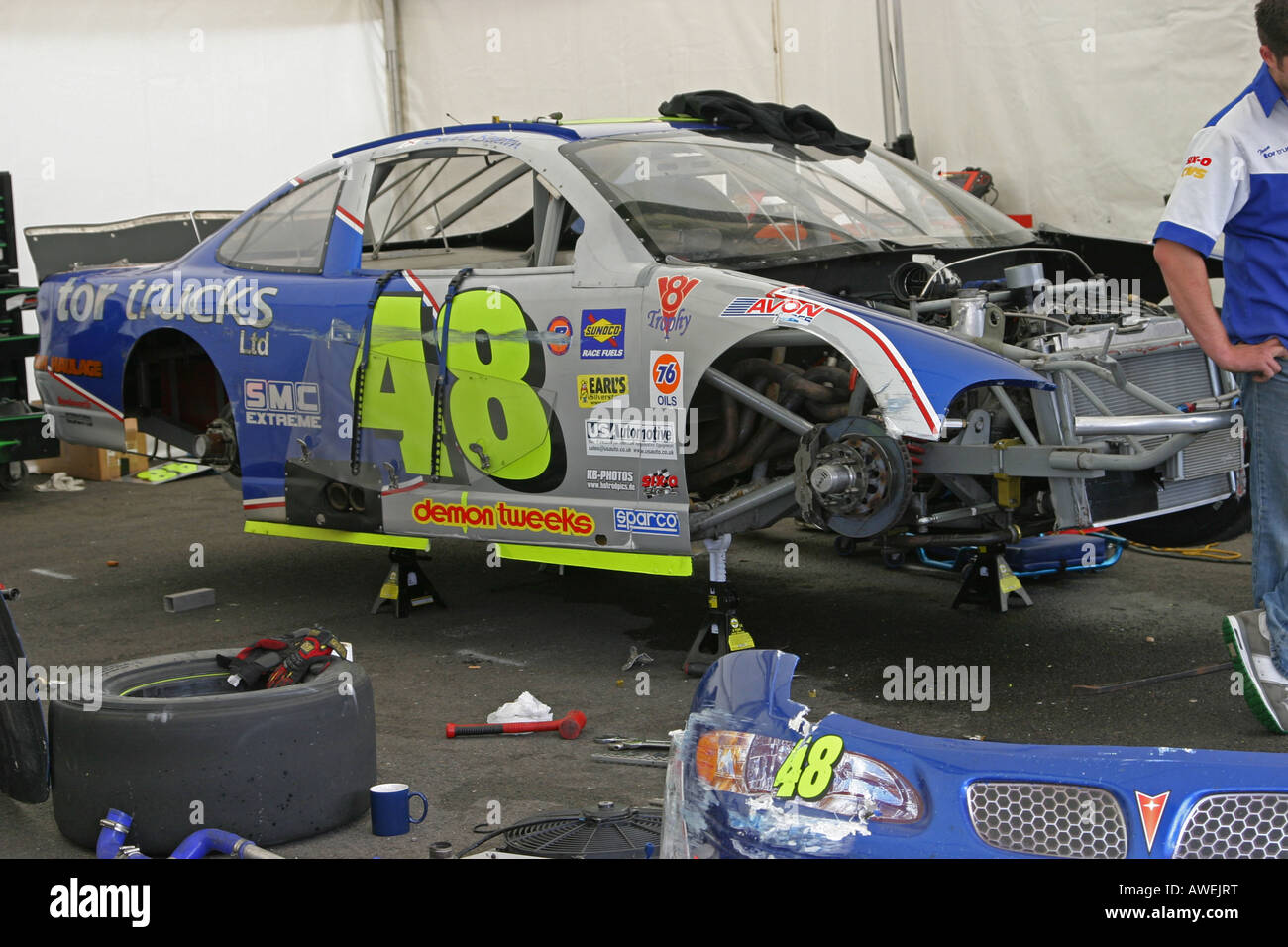 V8 stock car in pieces in the garage after being involved in a crash ...