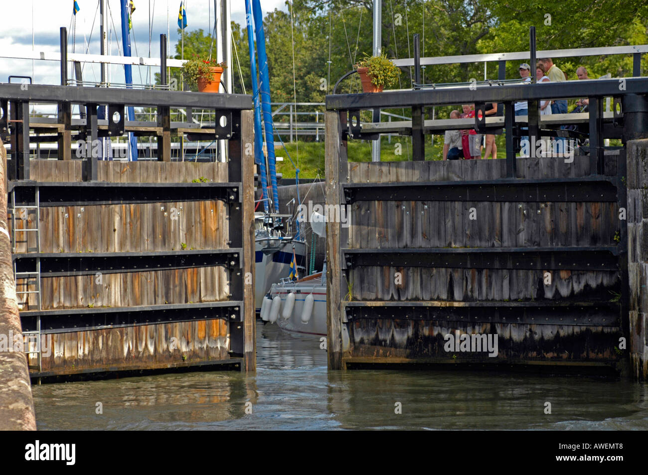 boats behind an opening watergate sluice lock in the Göta Canal at ...