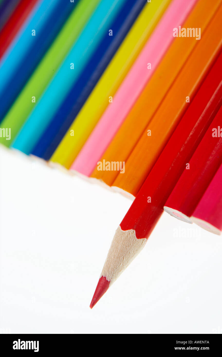 RED PENCIL WITH SHARP POINT STICKING OUT FROM ROW OF COLORED PENCILS ...