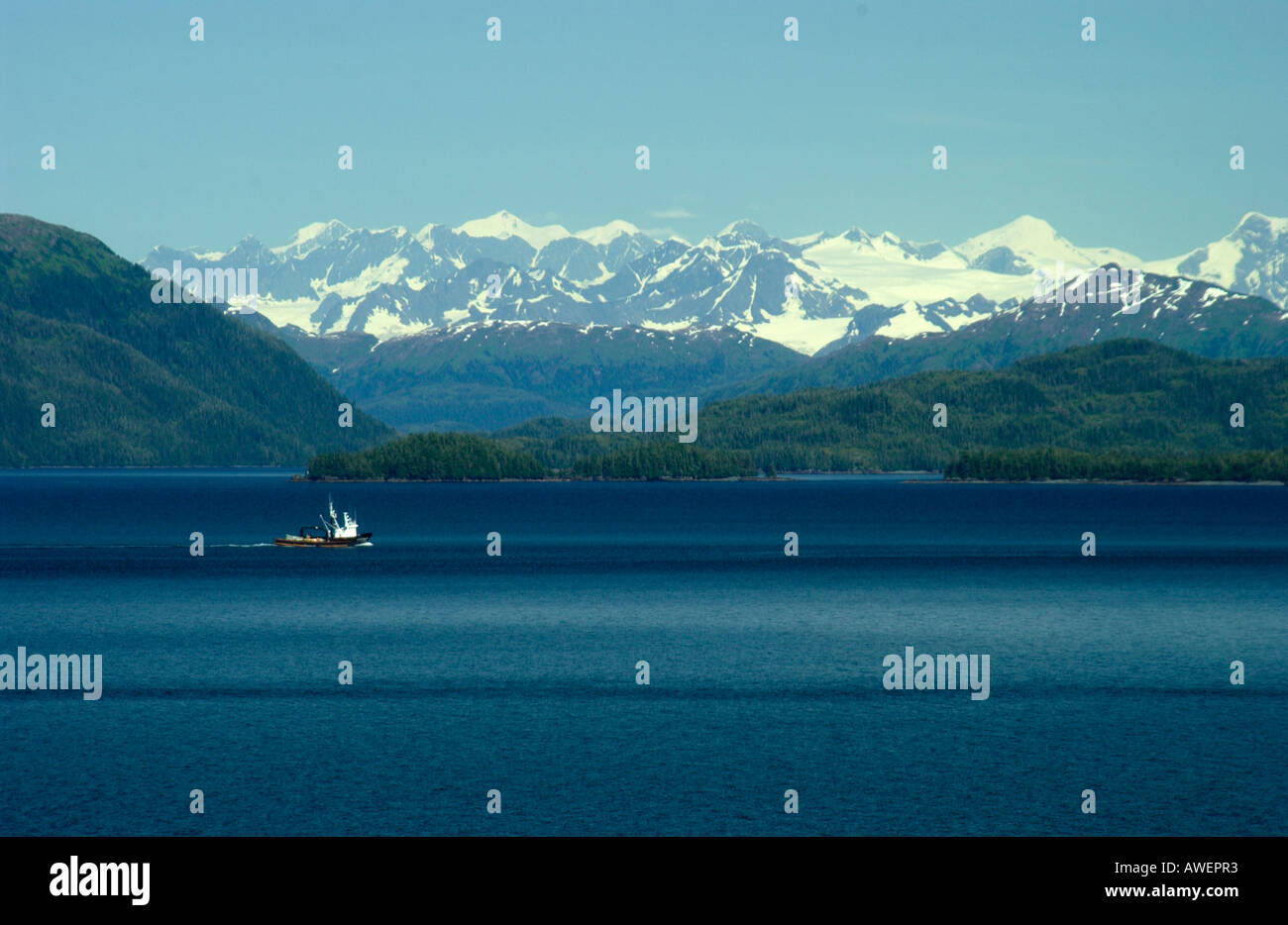 Photo of mountains and a fishing boat in Prince William Sound, Alaska ...