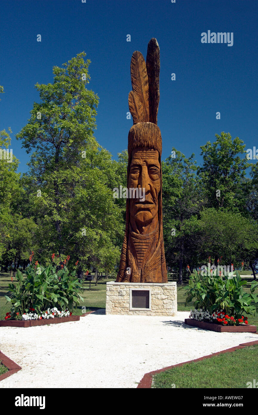 A tall cedar wood carving of an Anishinabe Indian at Winnipeg Beach ...