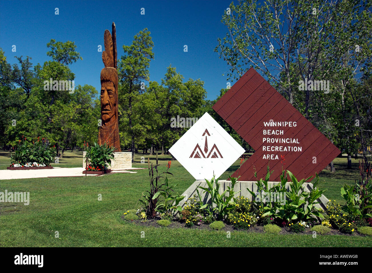 A tall cedar wood carving of an Anishinabe Indian at Winnipeg Beach ...