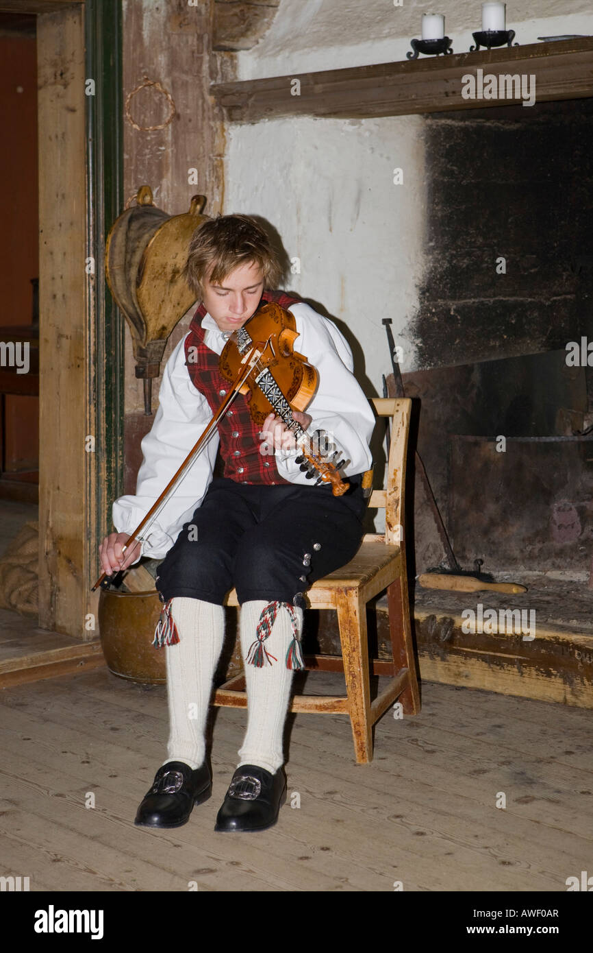 Fiddler playing a traditional Hardanger fiddle at an open air (living ...