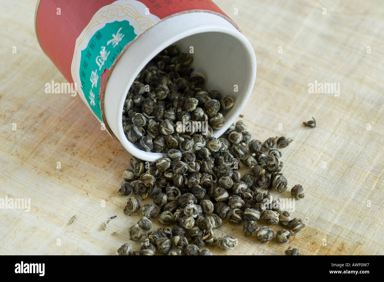 Pearl jasmine tea pellets spilling out of their packaging Stock Photo ...