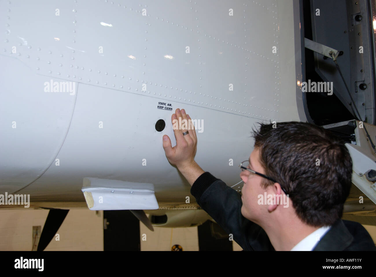 A pilot does a preflight check,making sure that the static ports are ...