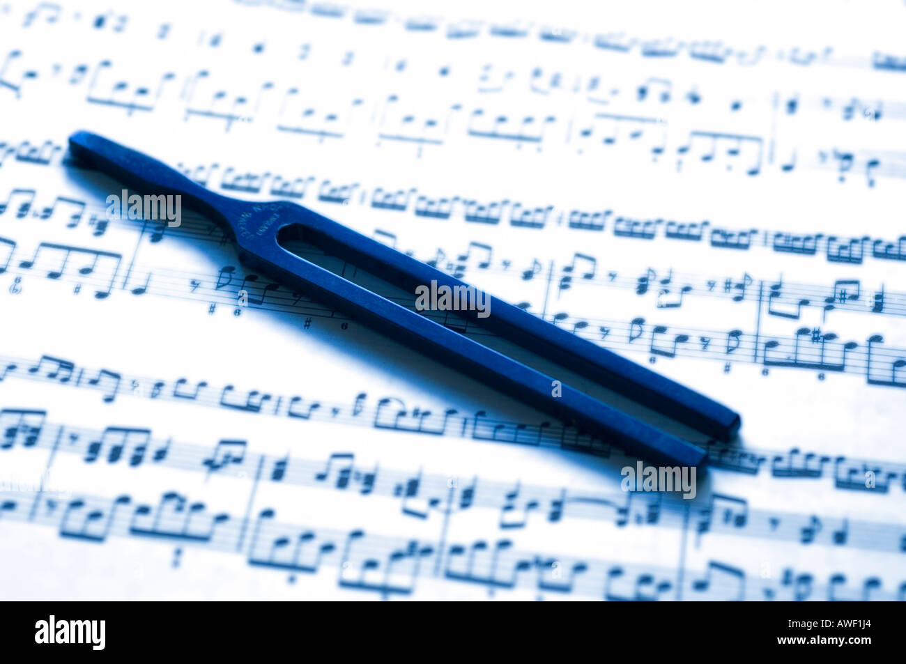 tuning fork lying on sheet music Stock Photo - Alamy