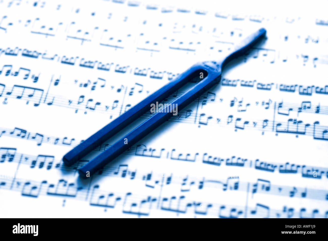 tuning fork lying on sheet music Stock Photo - Alamy