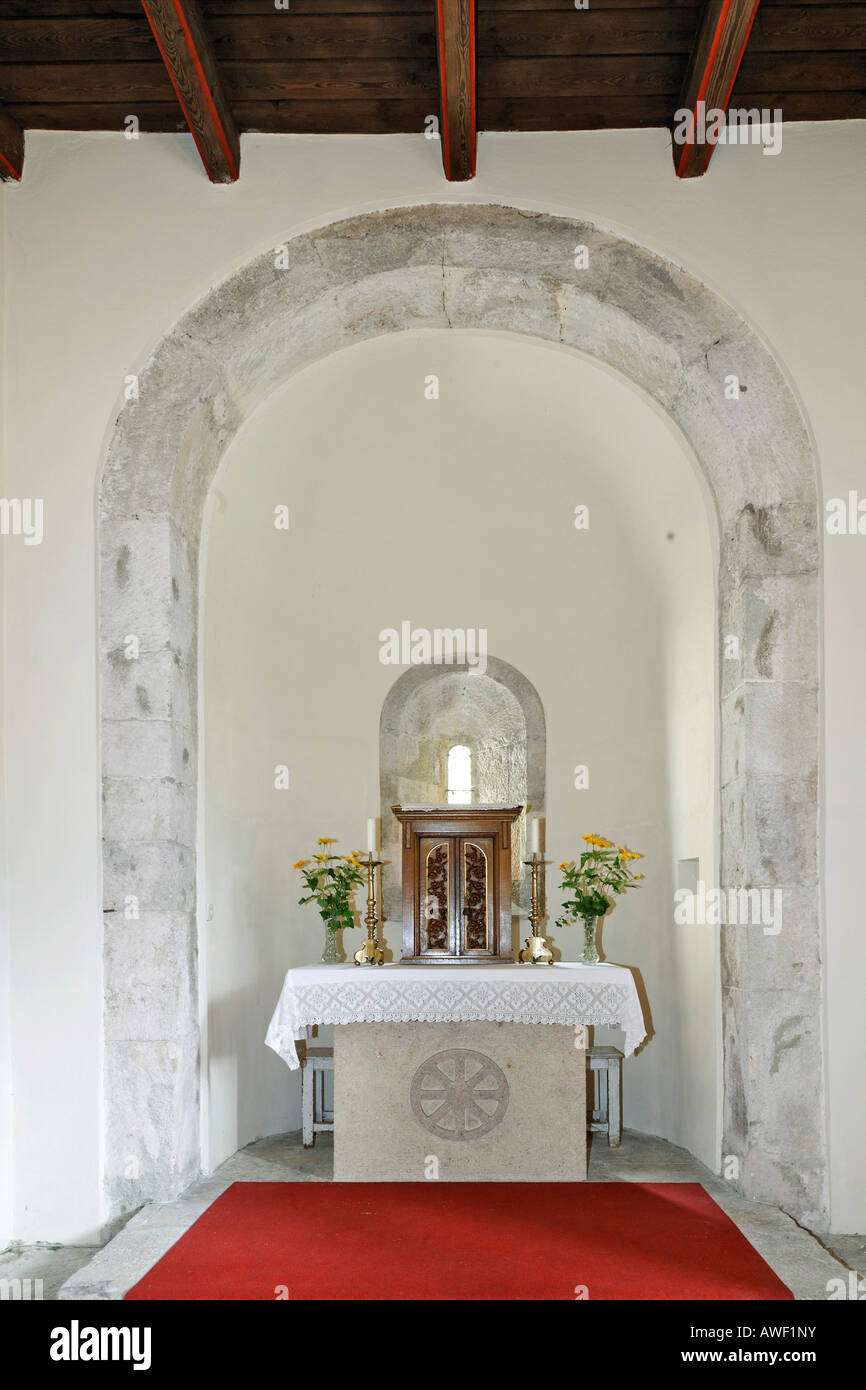 Altar in front of a round-arched window in the Romanesque church in ...
