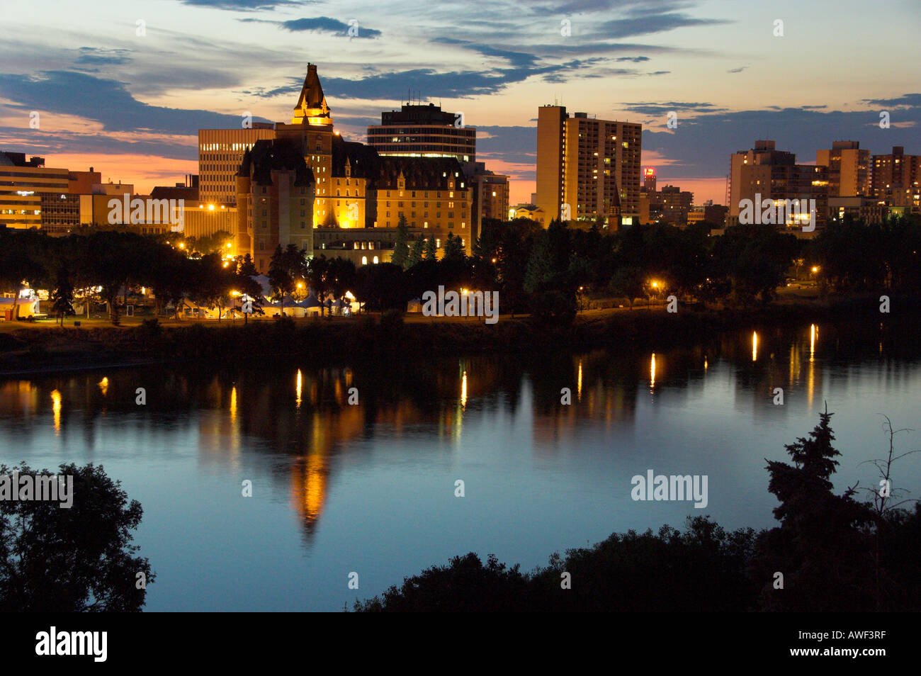 The Saskatoon city skyline across the South Saskatchewan river at dusk ...