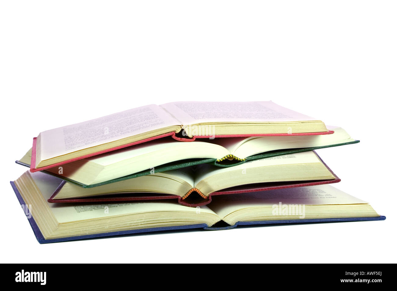 Four old books open and on top of each other isolated on white Stock ...