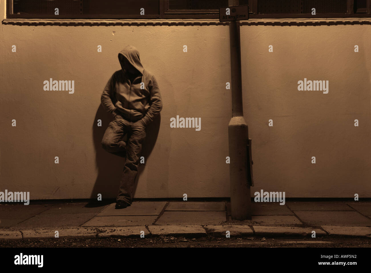 Youth hanging around under a street time at night Stock Photo - Alamy