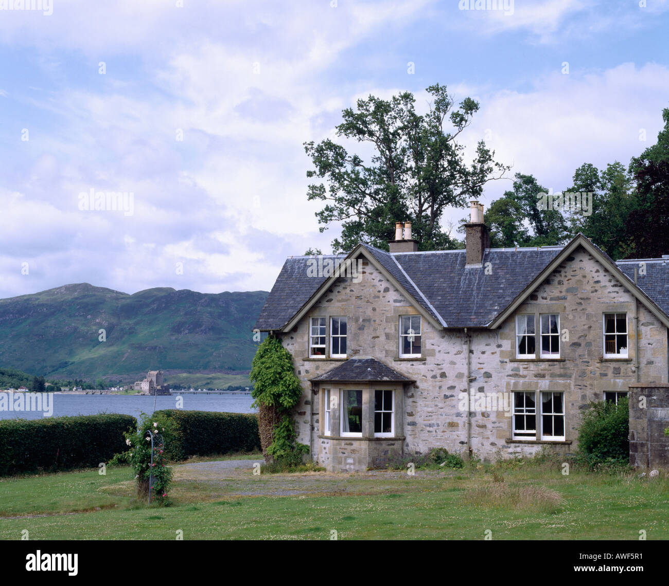 Traditional stone Victorian house on the banks of a Scottish loch Stock ...