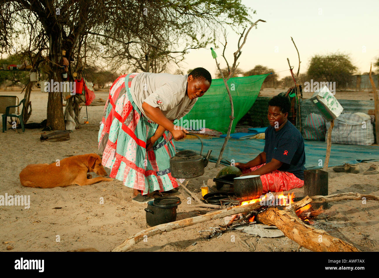 Two women cooking at the campfire, Cattlepost Bothatoga, Botswana ...