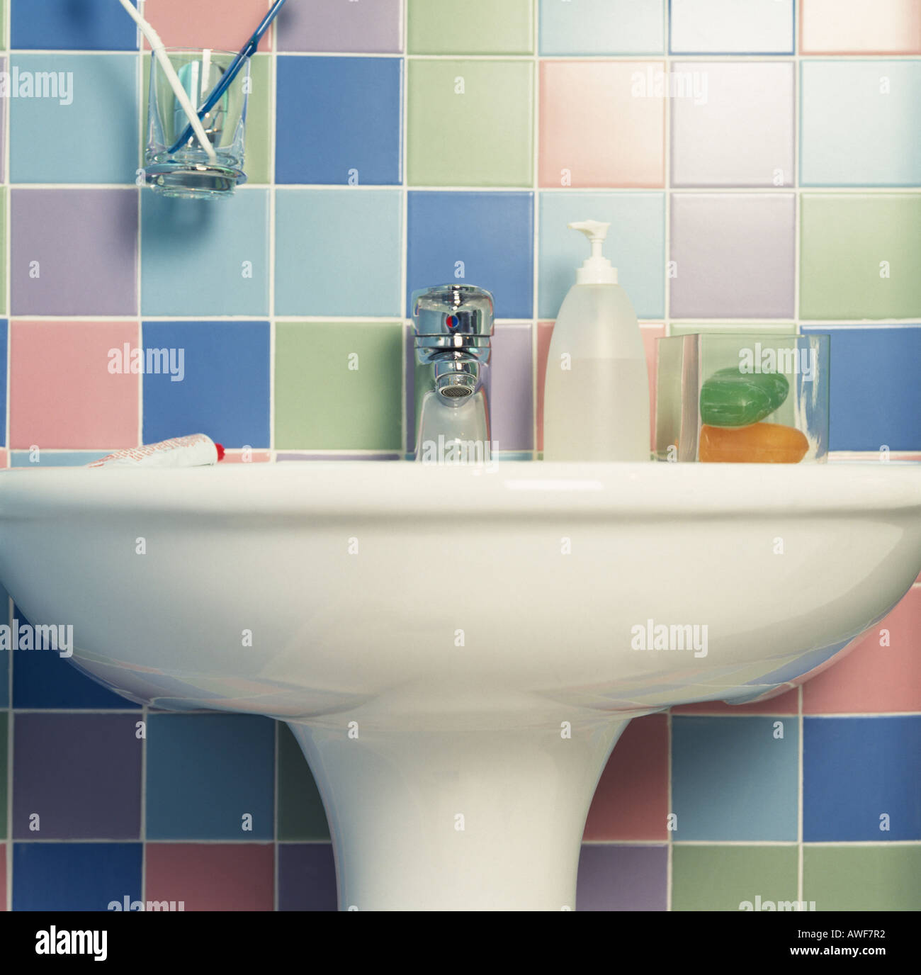 Coloured tiles behind bathroom basin Stock Photo - Alamy