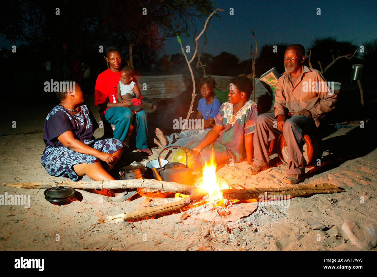 Group of people at the campfire, Cattlepost Bothatoga, Botswana, Africa ...