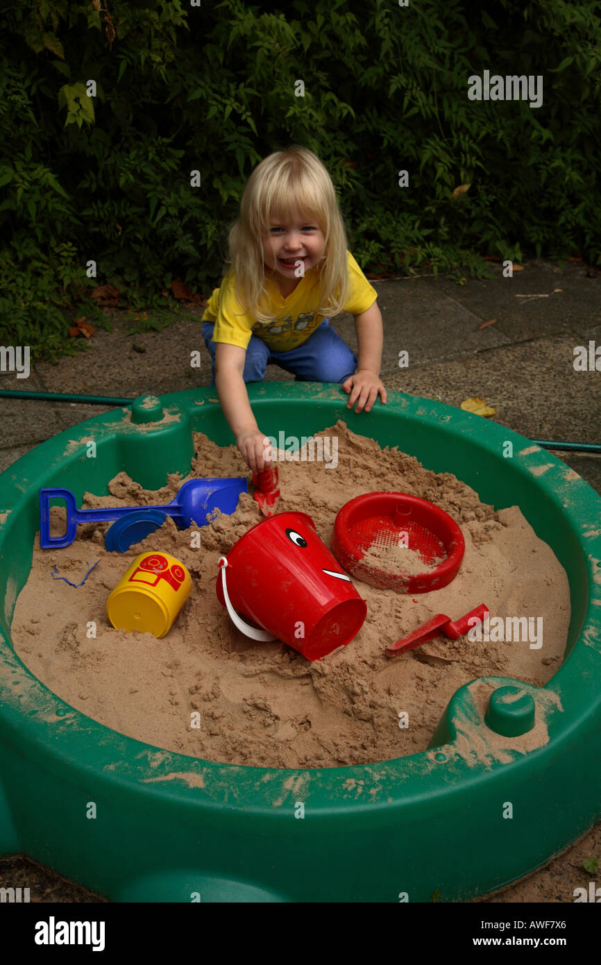 Girl playing in sand pit hi-res stock photography and images - Alamy