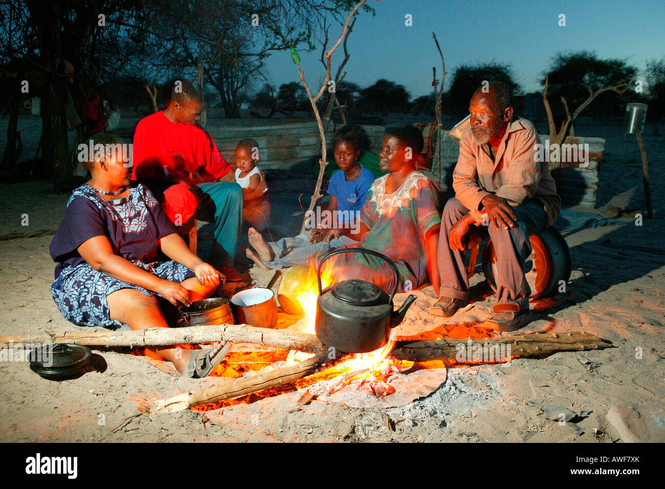 Group of people at the campfire, Cattlepost Bothatoga, Botswana, Africa ...