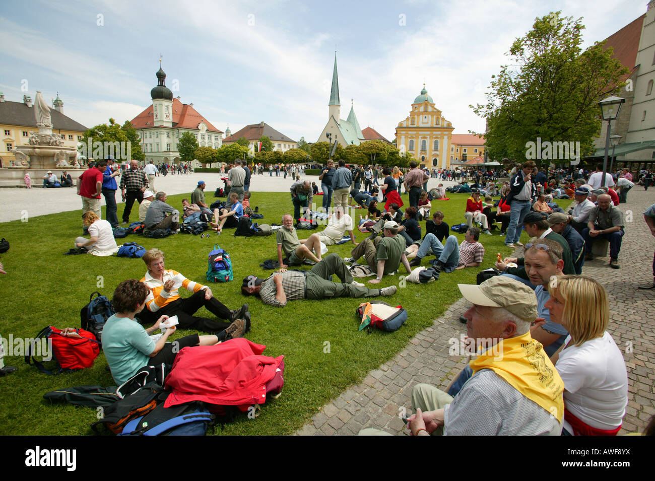 Pilgrims resting on the Kapellplatz (chapel square) in Altoetting ...