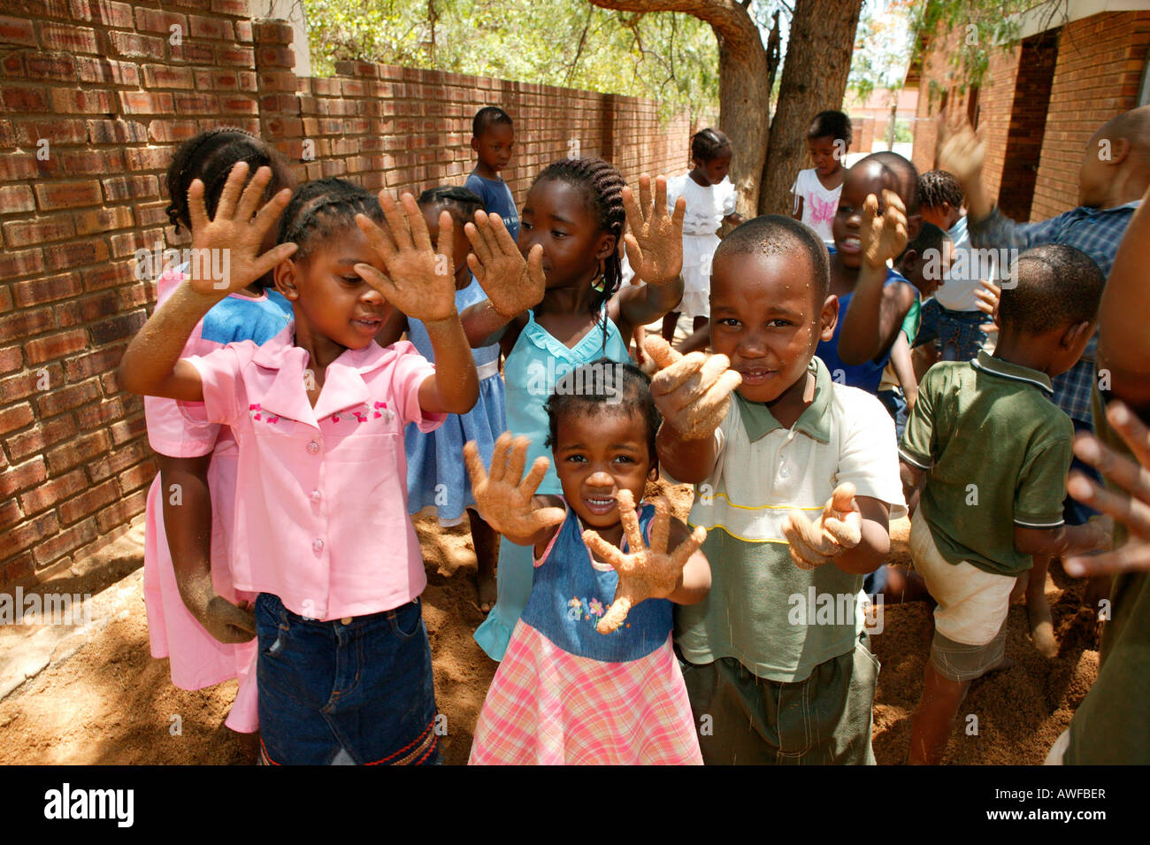Children showing their sandy hands at a kindergarten, Gaborone ...
