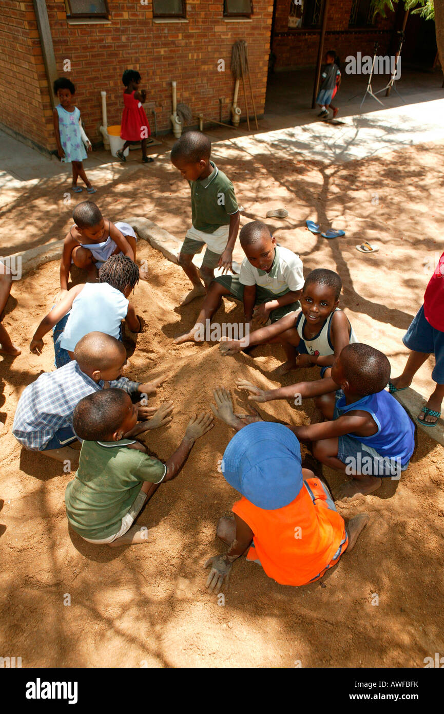 Children playing in the sand at a kindergarten, Gaborone, Botswana ...