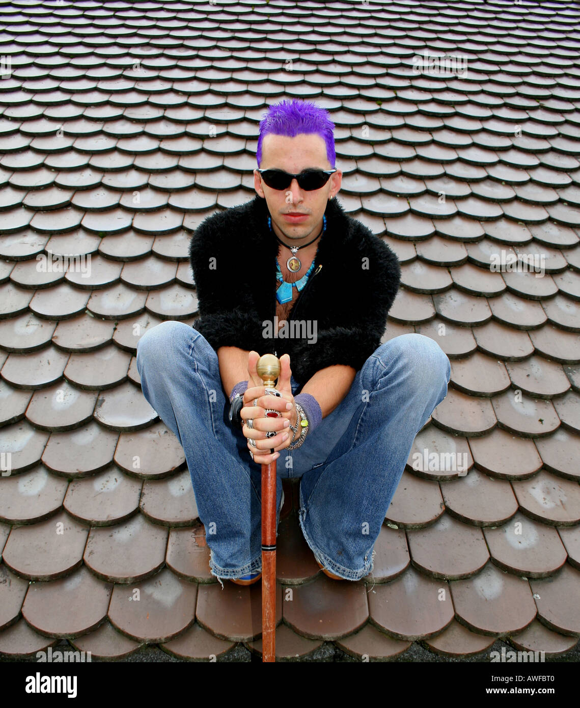 young punk sitting on roof top Stock Photo - Alamy