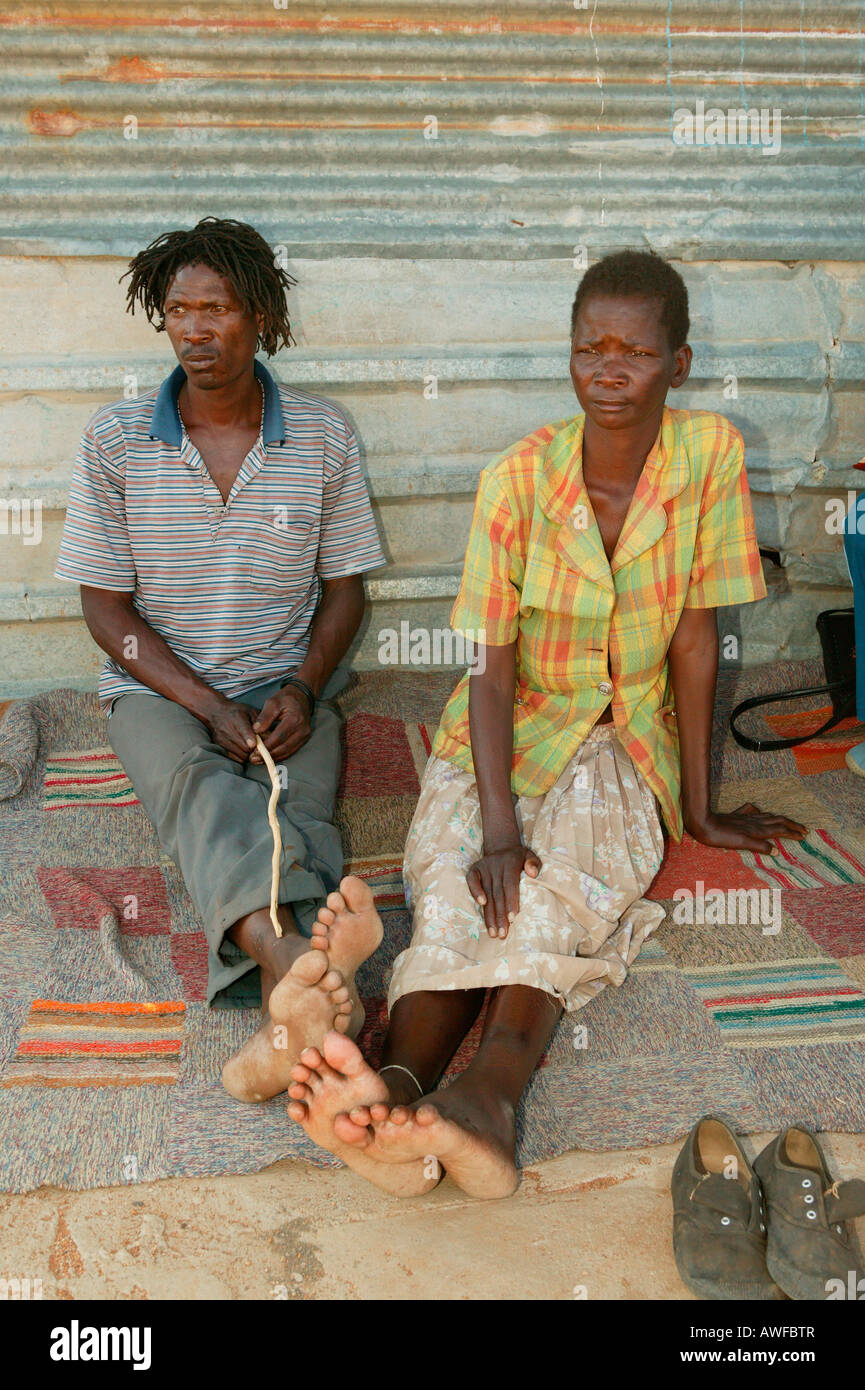 HIV/AIDS infected couple in front of their corrugated metal hut ...