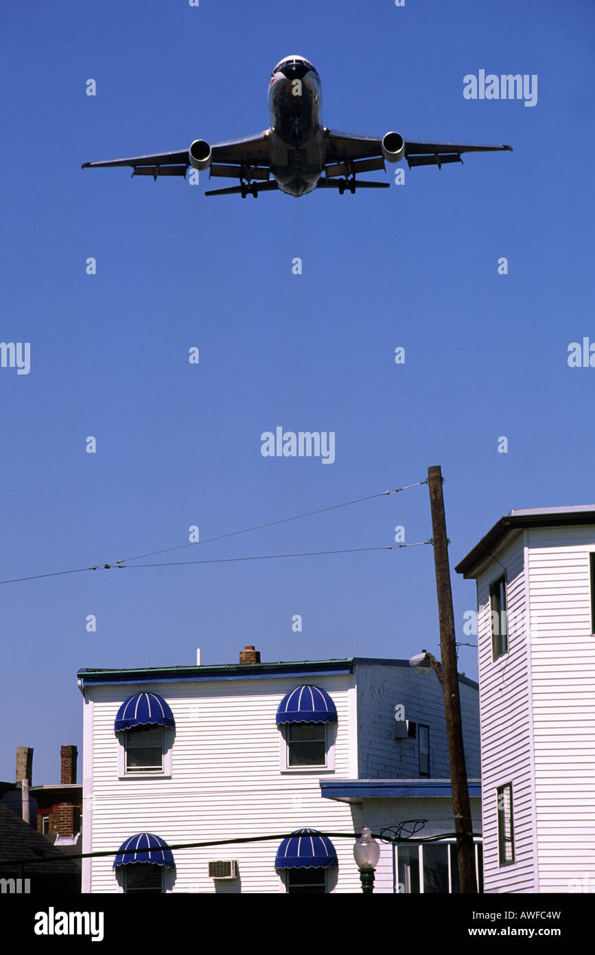A jet plane lands at Logan International airport over the residential ...