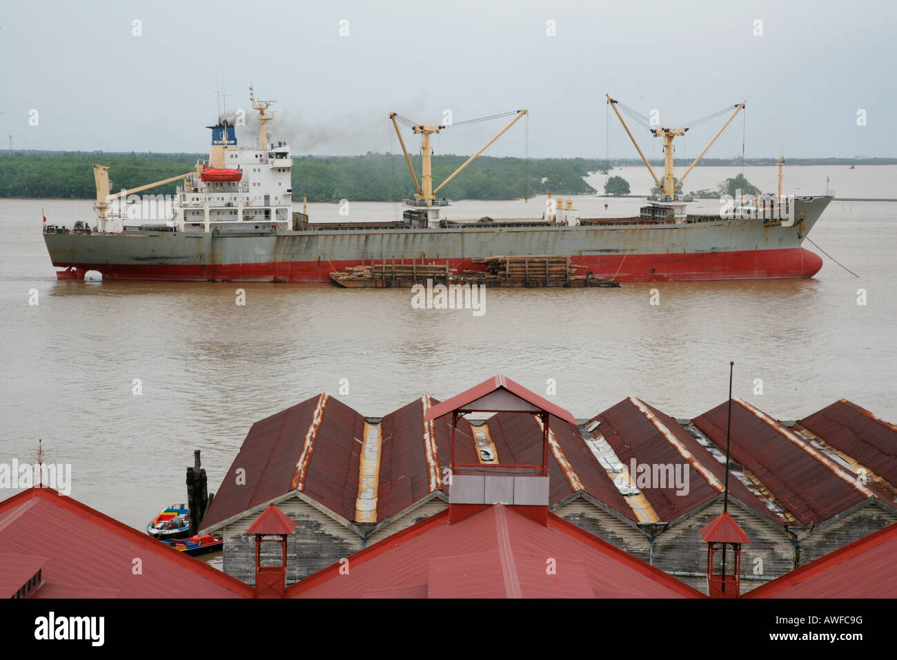 Loading exotic woods at a container port along the Demerara River ...