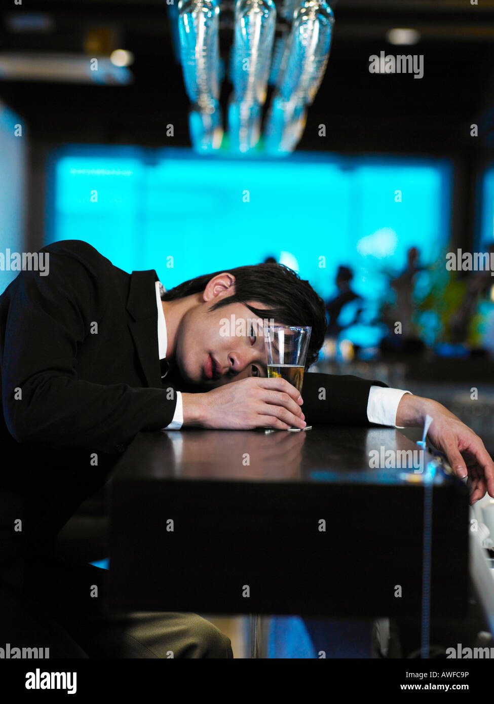 a tired businessman drinking at bar counter Stock Photo - Alamy